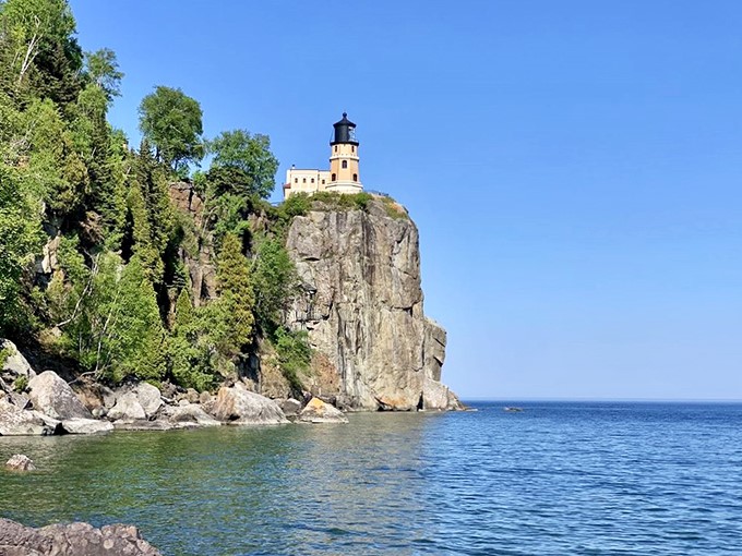 Sunset spectacle! Split Rock Lighthouse stands sentinel on its rocky perch, like a storybook castle guarding the shores of an enchanted lake.