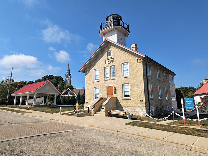 Ahoy there, lighthouse lovers! This cream city brick beauty stands tall and proud, like a maritime supermodel strutting her stuff on Lake Michigan's catwalk.