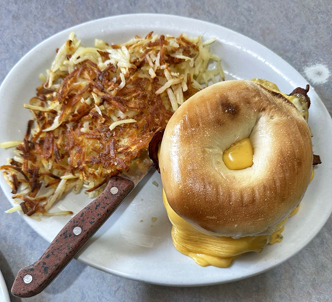 The breakfast sandwich that puts your sad desk lunch to shame. That melty cheese is doing the cha-cha with crispy hash browns.