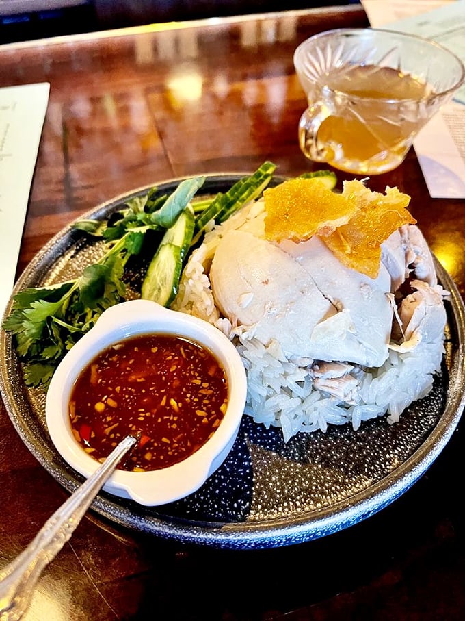 Hainan chicken that's a passport for your palate. Tender meat, fragrant rice, and a sauce that'll make you want to book a flight.