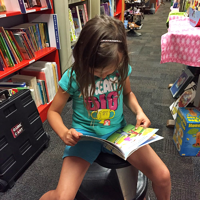 Starting them young! This little bookworm is diving deep into her next great adventure. Future bestseller in the making?