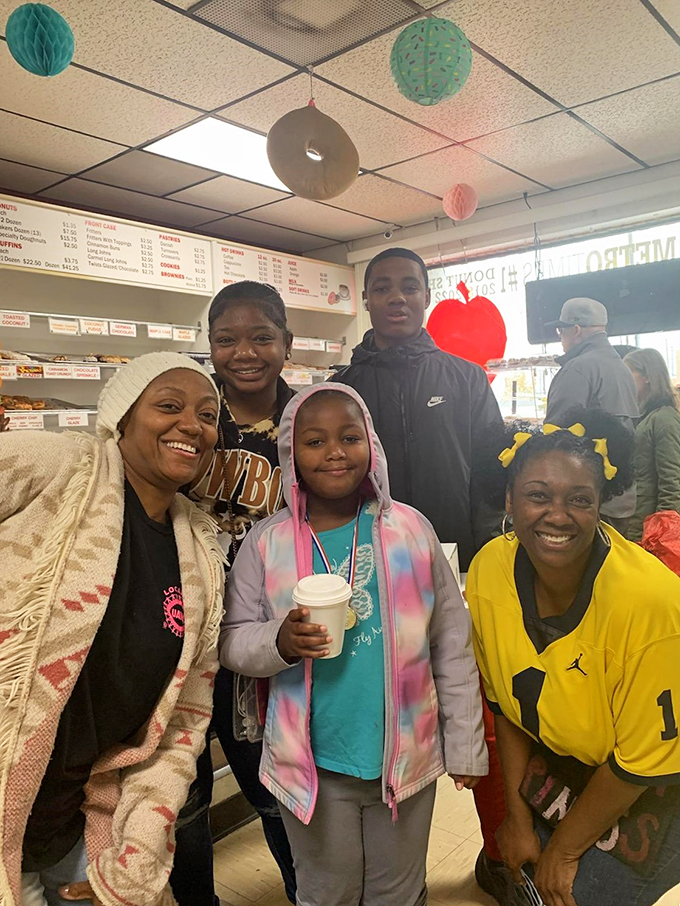 Smiles all around! These happy customers prove that donuts are the ultimate mood enhancer. Who needs therapy when you have fritters?