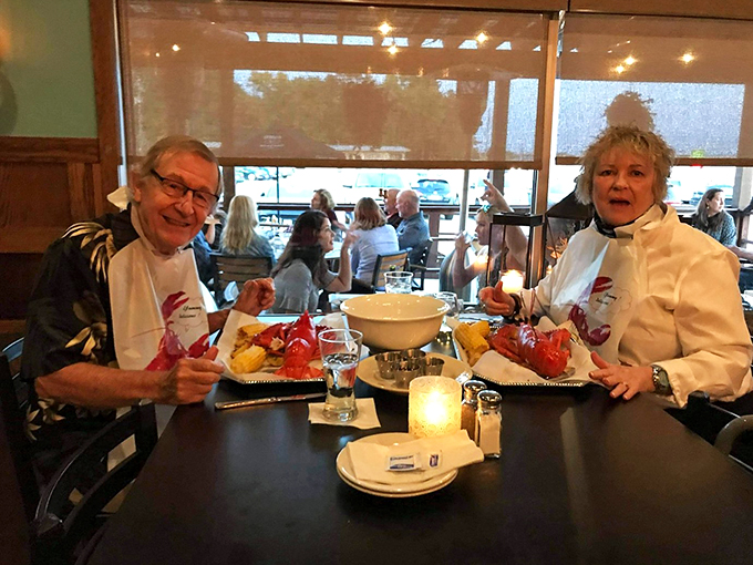 Happy diners diving into their seafood feast. Those bibs aren't just fashion statements &ndash; they're badges of delicious honor.