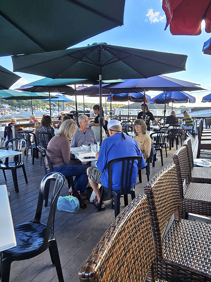 Sun, sea, and satisfied diners &ndash; the holy trinity of a perfect Maine afternoon. These folks have found their happy place, and it comes with a side of ocean breeze.