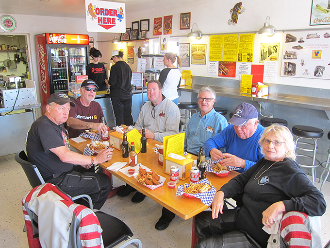 Hot dog enthusiasts unite! These happy diners know the secret to a good time: great food and even better company at Jimmy's.