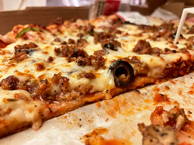 Meat lover's paradise! This pizza's got more toppings than a sundae bar. It's not a meal; it's a carnivore's carnival on a crust.