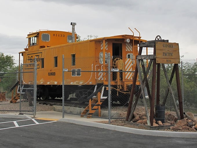 The little engine that could... and did! This full-sized caboose stands guard over its tinier counterparts, like a proud parent.