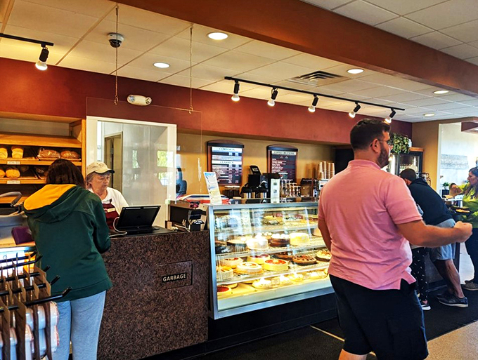 Happy customers in their natural habitat. Notice the intense focus &ndash; choosing the perfect pastry is serious business, folks!