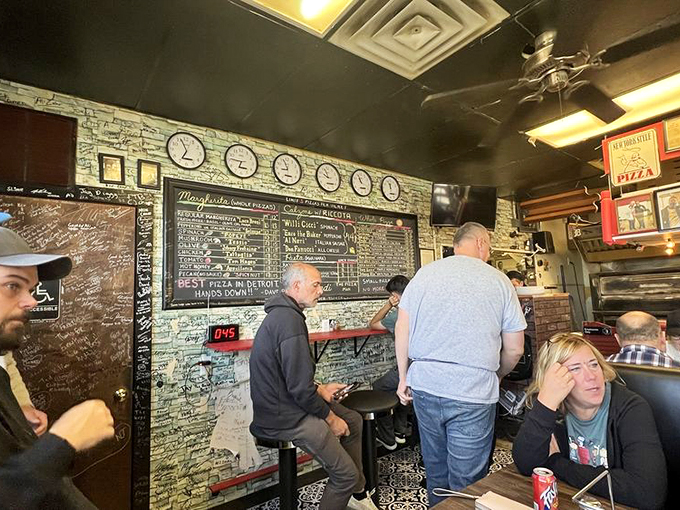 Pizza pilgrims unite! These diners are on a quest for the holy grail of slices, and judging by their expressions, they've found it at Fredi's.