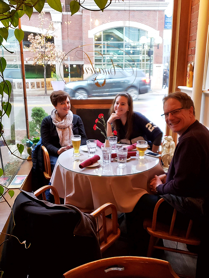 Happy diners basking in the glow of good food and great company. It's like a Norman Rockwell painting, but with better lighting and pierogies.