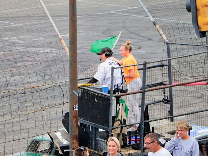 Green means go! These flag-waving officials are the traffic lights of the racetrack, keeping chaos at bay one wave at a time.