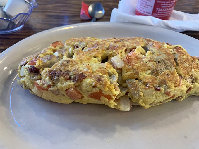 This omelet is so stuffed, it's practically bursting at the seams. It's like an edible treasure chest of breakfast delights!