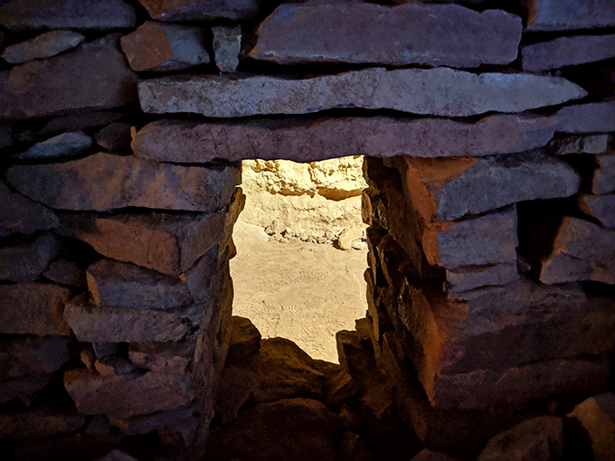 A stone window frames the desert beyond, creating a perfect Arizona postcard moment in these century-old walls.