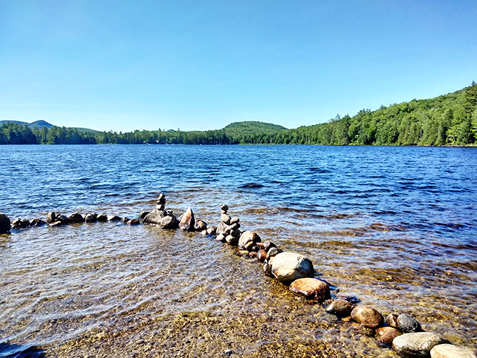 Ricker Pond's glassy surface: The perfect spot for contemplating life's big questions&hellip; or just your next snack.