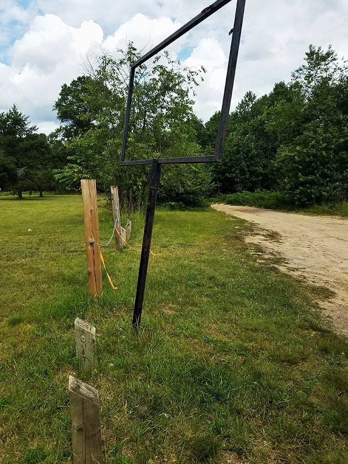 Nature reclaimed, spirits remained. This clearing in the woods is the ultimate 'ghost' town experience.