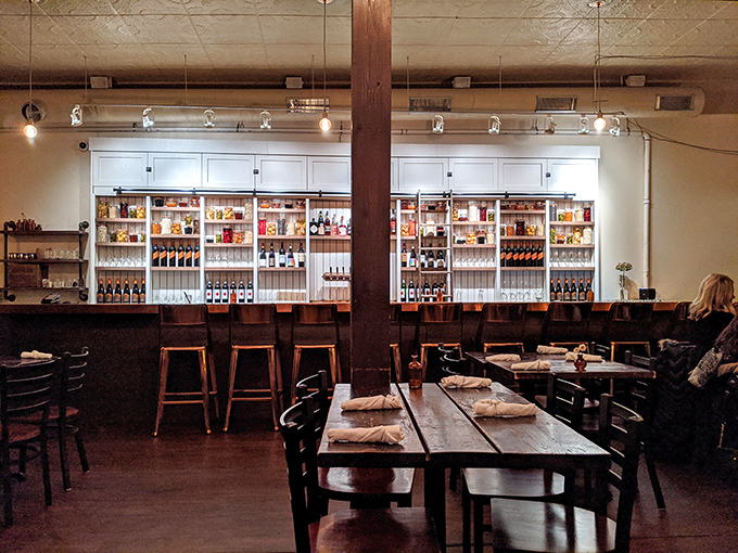 The bar area: Where libations meet expectations. With a bottle selection that impressive, you might need a treasure map to navigate your drink choices.