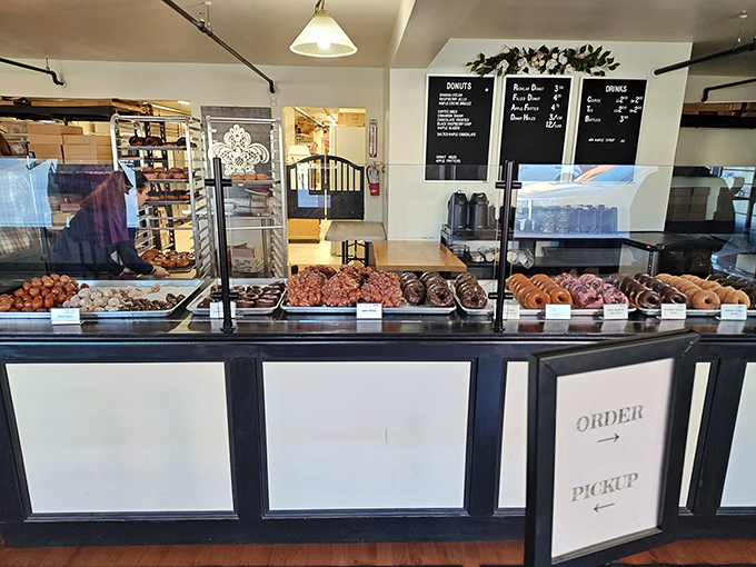 Behind this counter, dreams come true one donut at a time. The hardest part? Choosing just one.