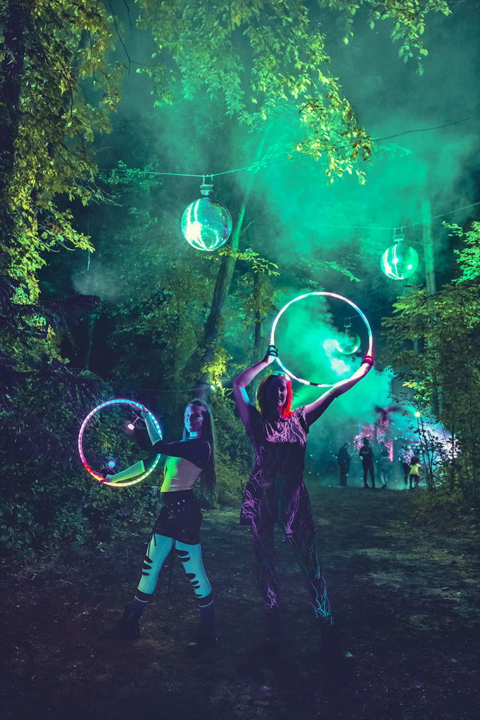 Hula hooping in Narnia! These performers are bringing the circus to the enchanted forest, one glowing ring at a time.