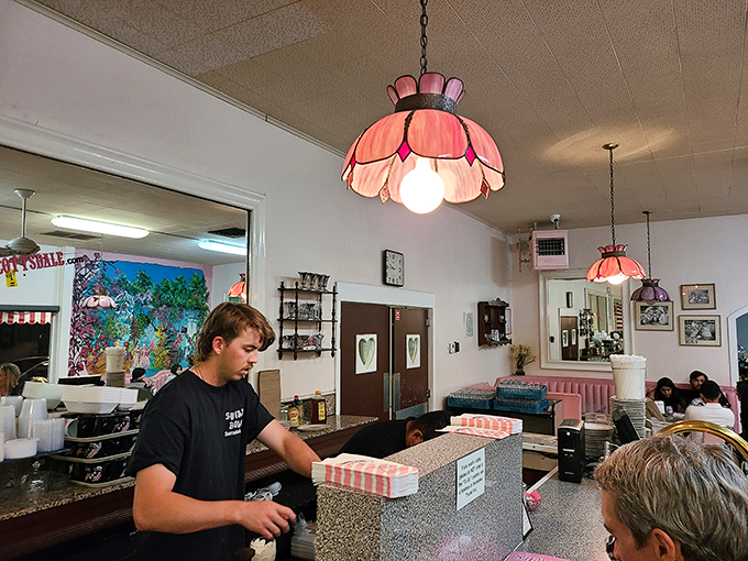 Soda jerk or dessert artist? This staff member is crafting more than sundaes; he's serving up edible memories one scoop at a time.