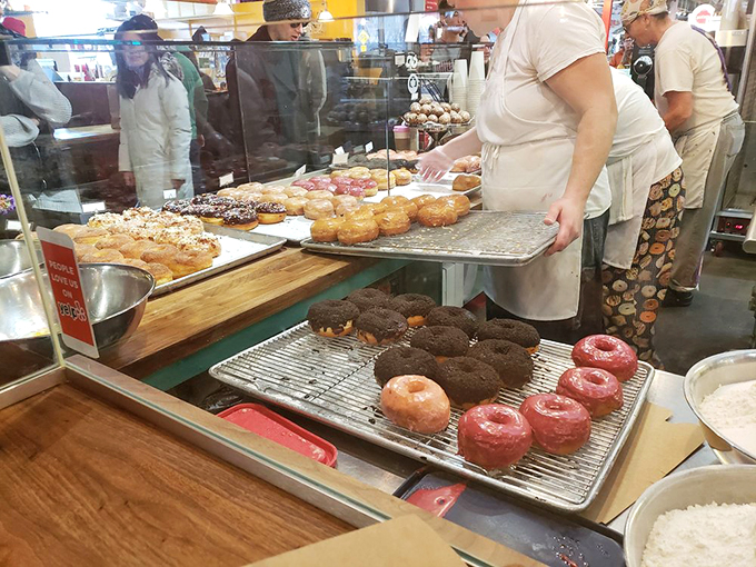 Masters at work! These donut artisans are like the Michelangelos of the pastry world, crafting edible masterpieces with flour, sugar, and a dash of magic.