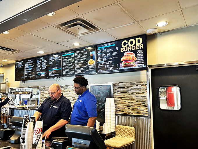 The burger dream team! These dedicated staff members are the unsung heroes behind your perfect patty. Give them a round of applause (and maybe a tip).