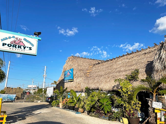 Porky's exterior: Porky's Bayside: Where tiki charm meets key lime bliss. It's like a luau for your taste buds!