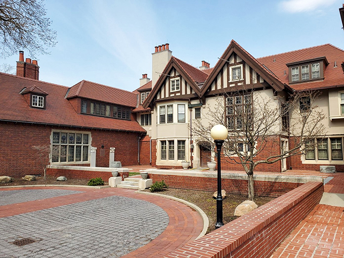 Tudor Revival meets modern art in a garden setting. It's like Shakespeare started a progressive school.