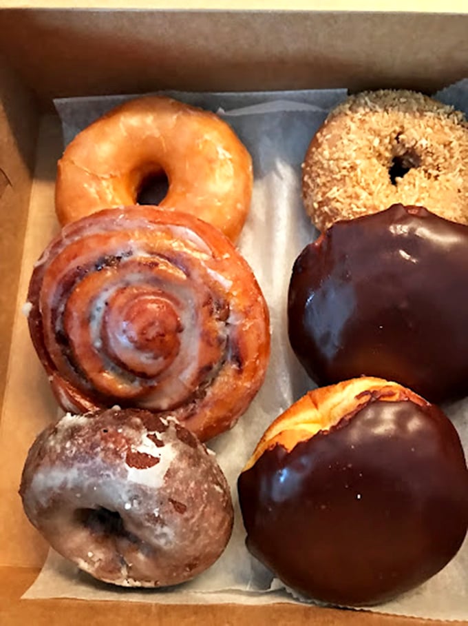 A box of joy, sprinkled with happiness. These donuts are like edible mood rings &ndash; each one a different flavor of delight.