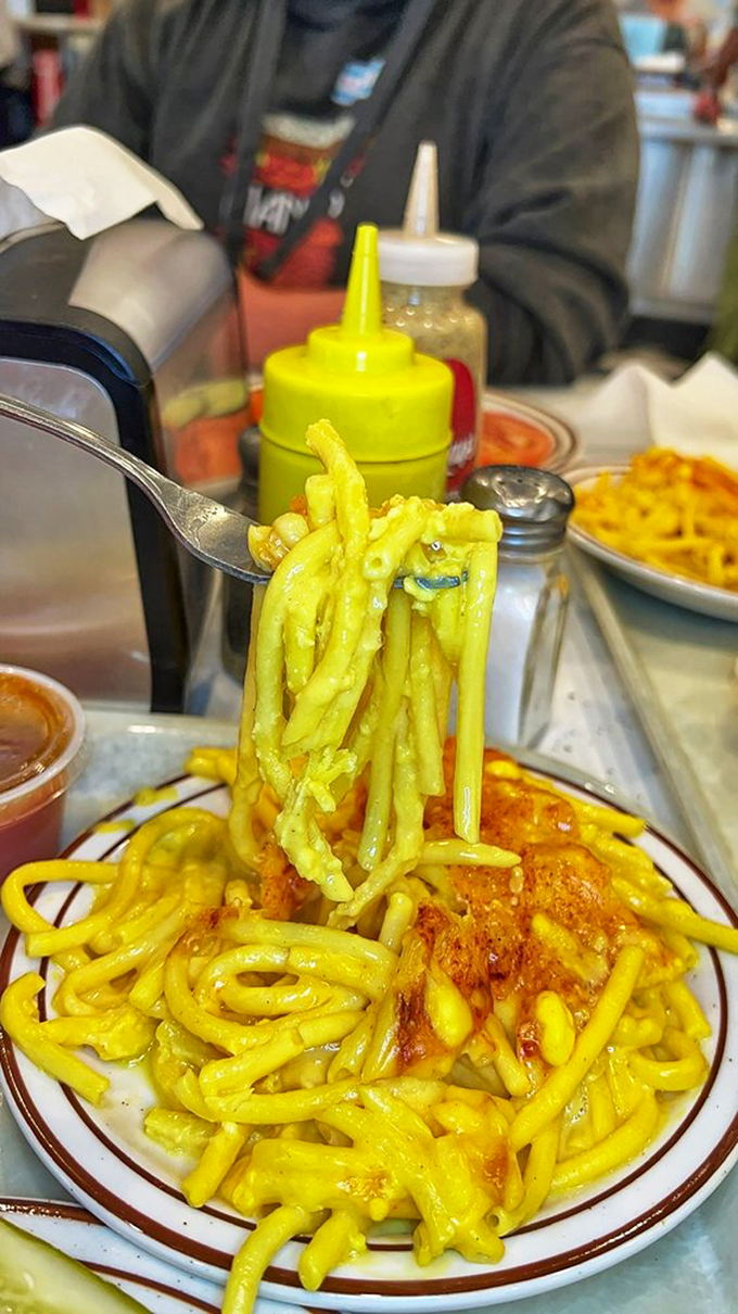 Mac and cheese so vibrant, it could double as a safety vest. Fork-lifting skills required for maximum cheesy, stringy satisfaction.