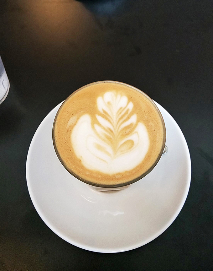 Latte art that's almost too pretty to drink. Almost. This coffee is the perfect companion for your literary journey.