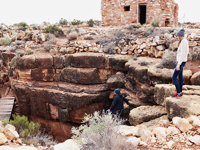 Intrepid visitors explore the cave's rocky entrance, where history and mystery meet in equal measure.