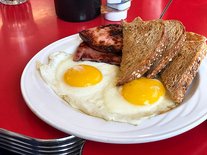 Sunny-side up perfection! These eggs are so fresh, they might just cluck. And that toast? Golden-brown bliss.
