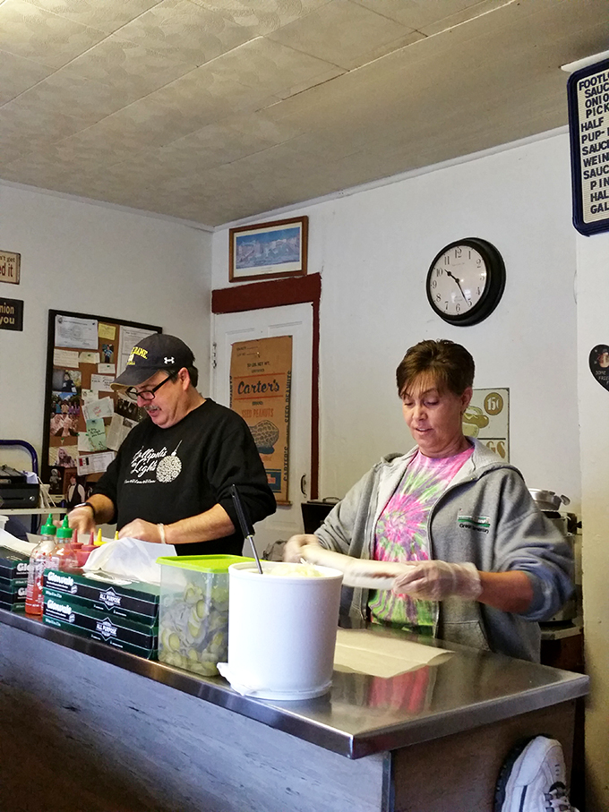 Hot dog heaven in action! Witness the culinary choreography as orders fly and grills sizzle with delicious anticipation.