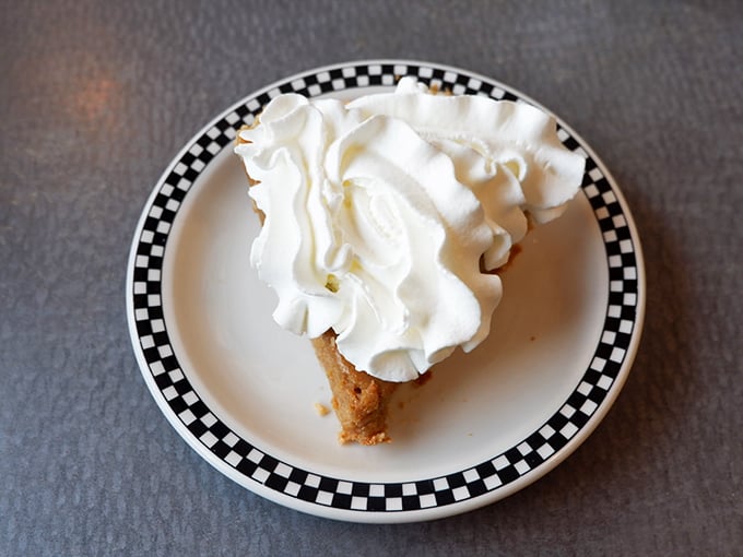 Whipped cream mountain on a pie summit. This dessert isn't just served; it's presented with the fanfare it deserves.