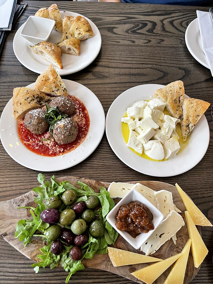 Feast your eyes on this spread! From meatballs to mozzarella, it's a smorgasbord of Italian delights that'll make you want to kiss your fingers like a cartoon chef.