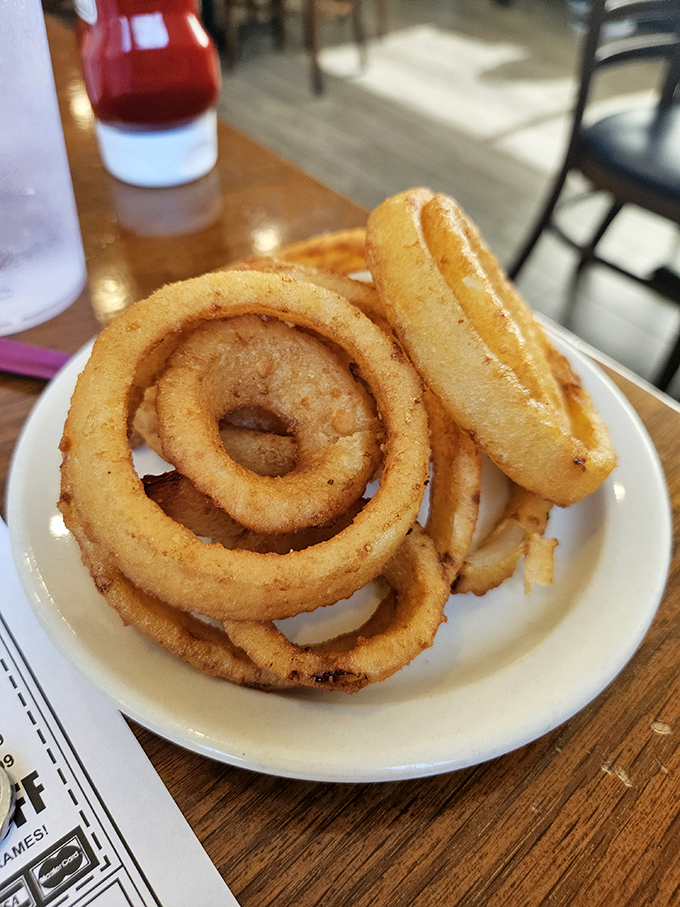 Burger bliss achieved! This towering masterpiece, flanked by crispy fries, is the stuff of diner dreams. It's not a meal, it's a monument to American ingenuity.