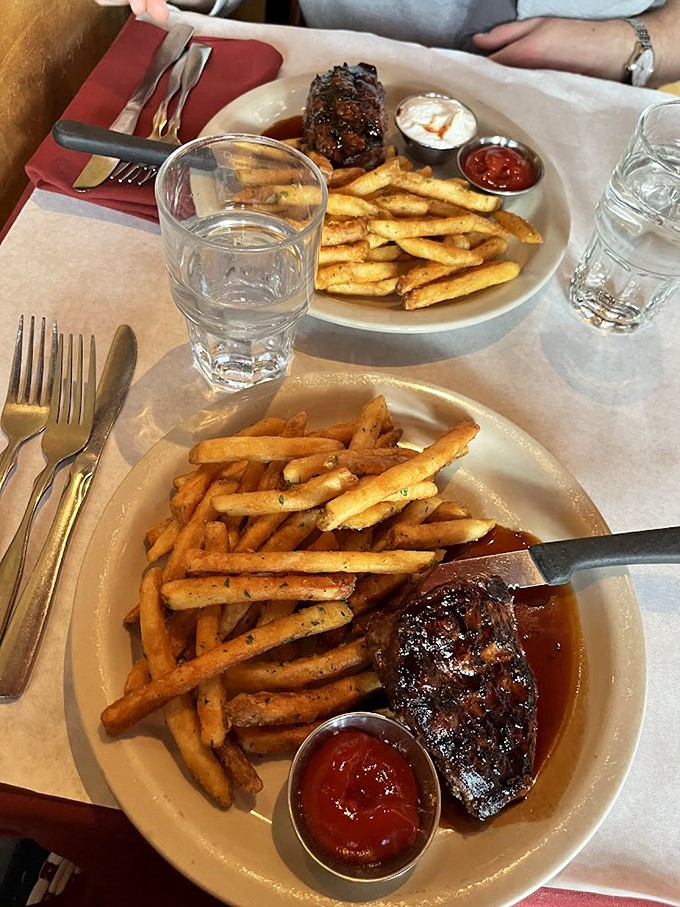 Two steaks walk into a bar... and end up on your plate, surrounded by a sea of golden fries.