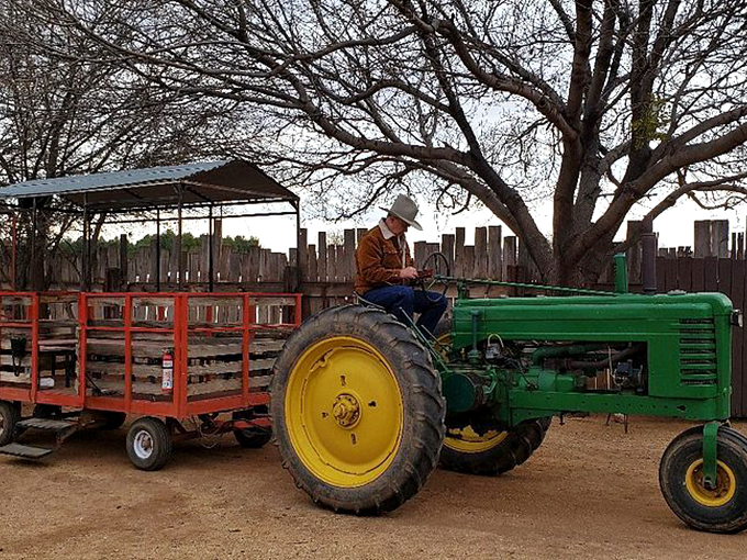 Giddy up, green machine! This tractor's hauling more than hay &ndash; it's carrying dreams of the Wild West.