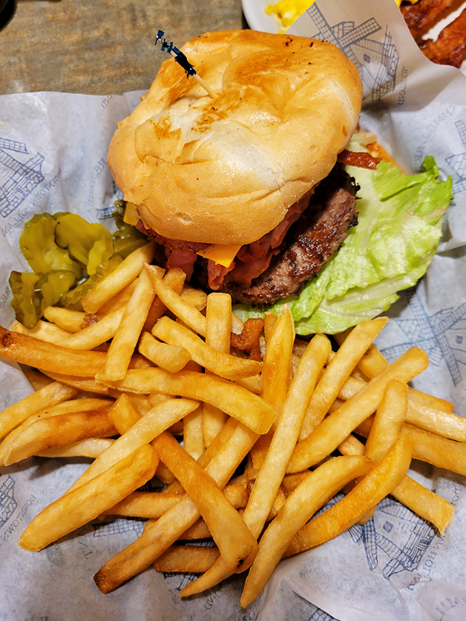 Burger bliss! This towering creation and its crispy sidekick are ready to make your cheat day dreams come true.