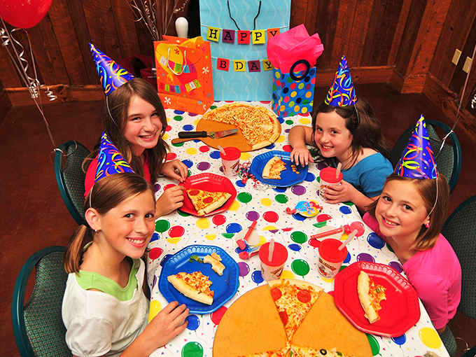 Birthday bash central! With pizza, party hats, and beaming faces, it's a recipe for memories sweeter than the cake itself.
