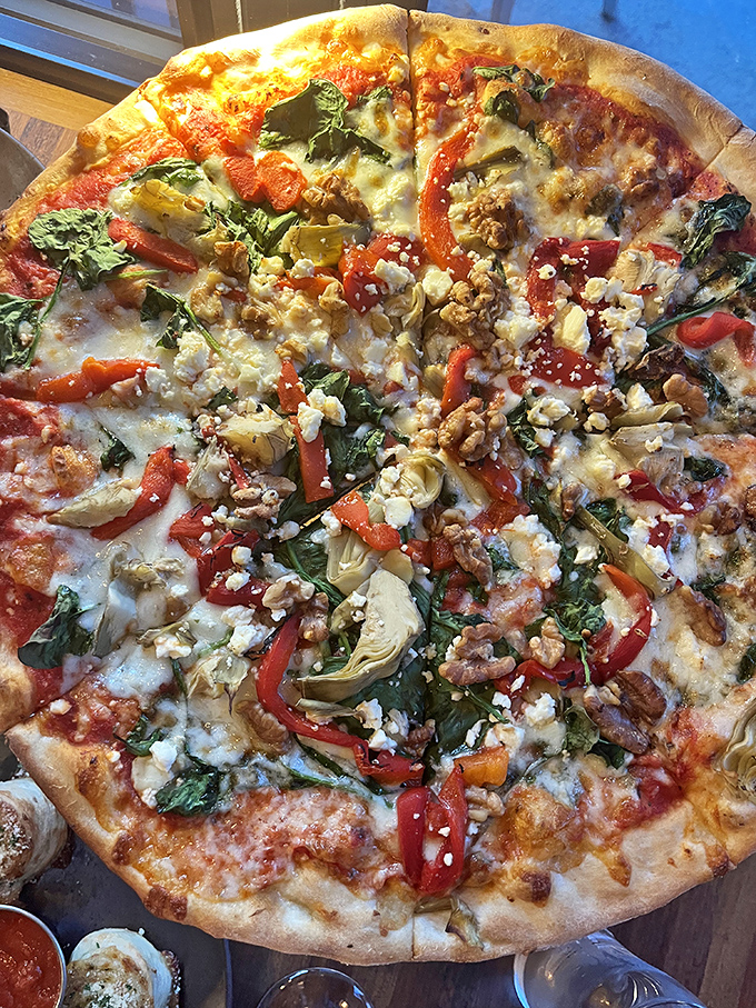 A pizza so loaded, it's like a garden party on a crust. Every bite is a new adventure in flavor.