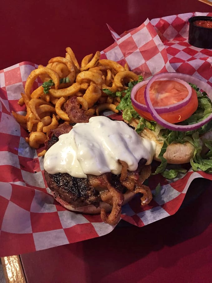 Burger bliss achieved! This juicy masterpiece, topped with a cascade of toppings, is ready for its burger beauty pageant crown.