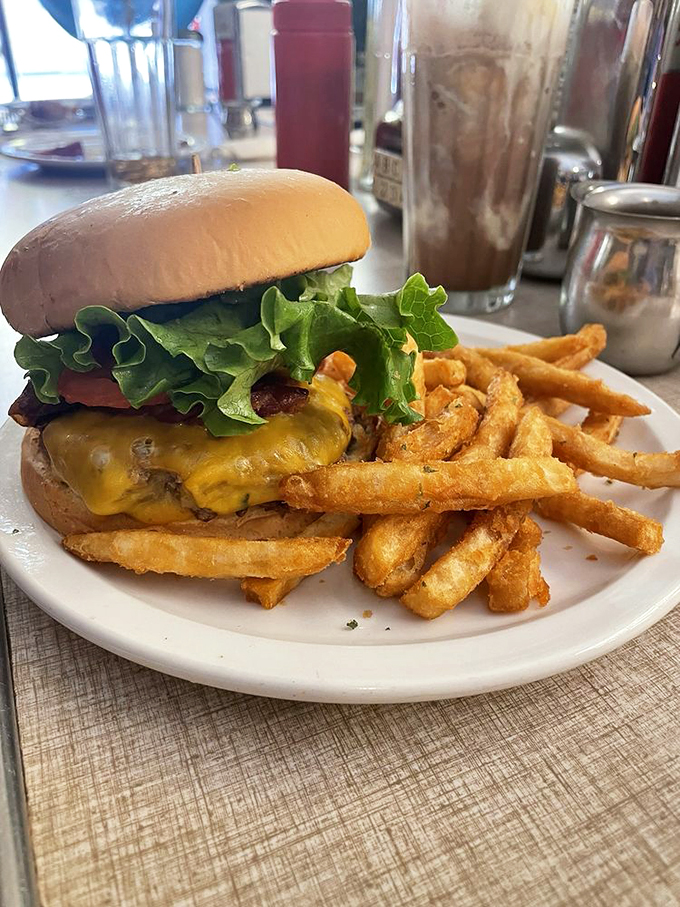 Burger bliss! This juicy masterpiece, complete with melty cheese and crisp lettuce, is proof that classics never go out of style.