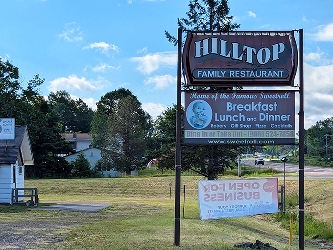 The beacon of breakfast bliss! This sign doesn't just mark a restaurant; it's a siren call to all who appreciate the finer things in life, like giant cinnamon rolls.
