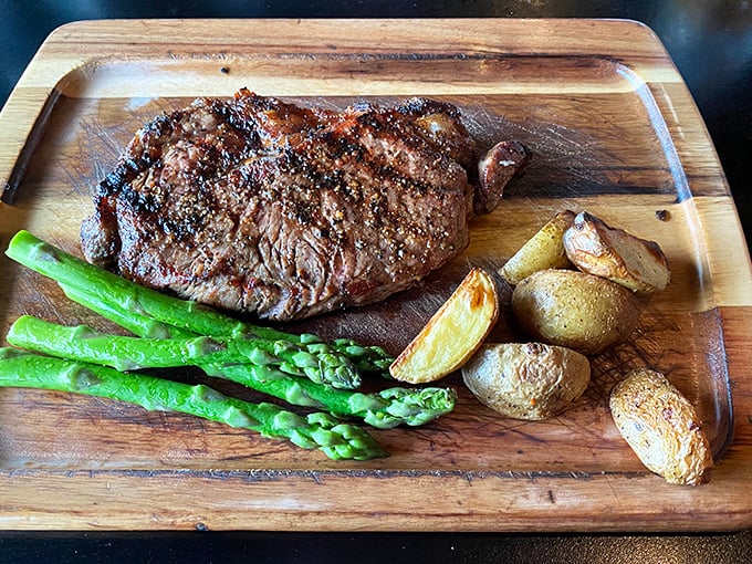 Who says it's all about seafood? This steak's ready for its close-up, and it's bringing the green team for backup.