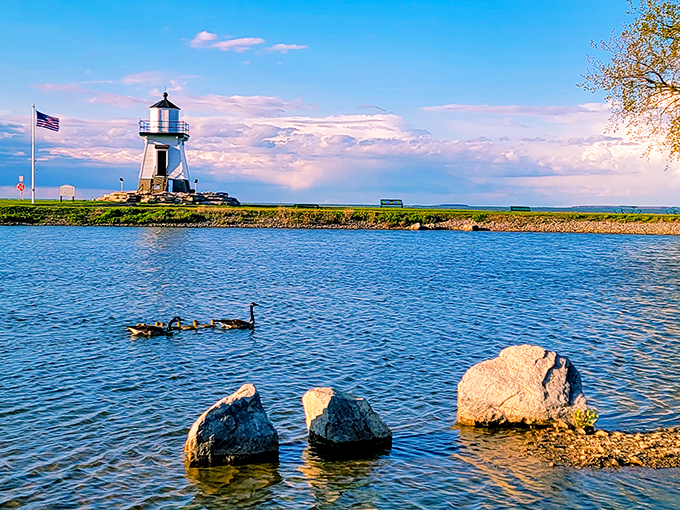 Nature's light show! This sunset could give Broadway a run for its money, with the lighthouse as the perfect opening act.