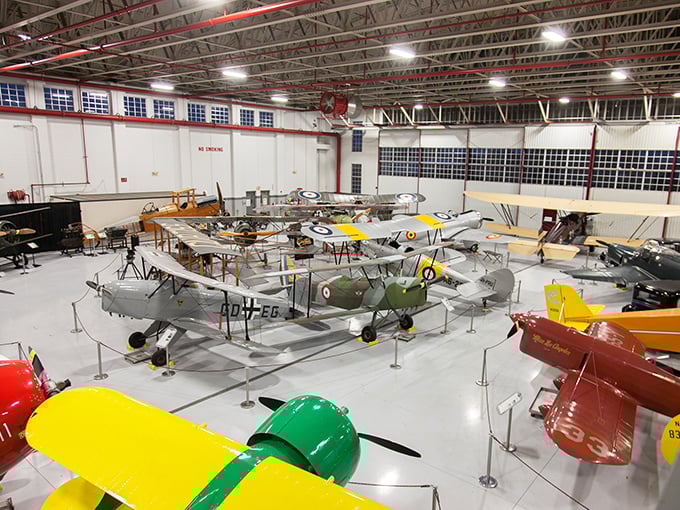 From above, the hangar floor becomes a colorful canvas of aviation history, each aircraft precisely positioned like museum pieces.