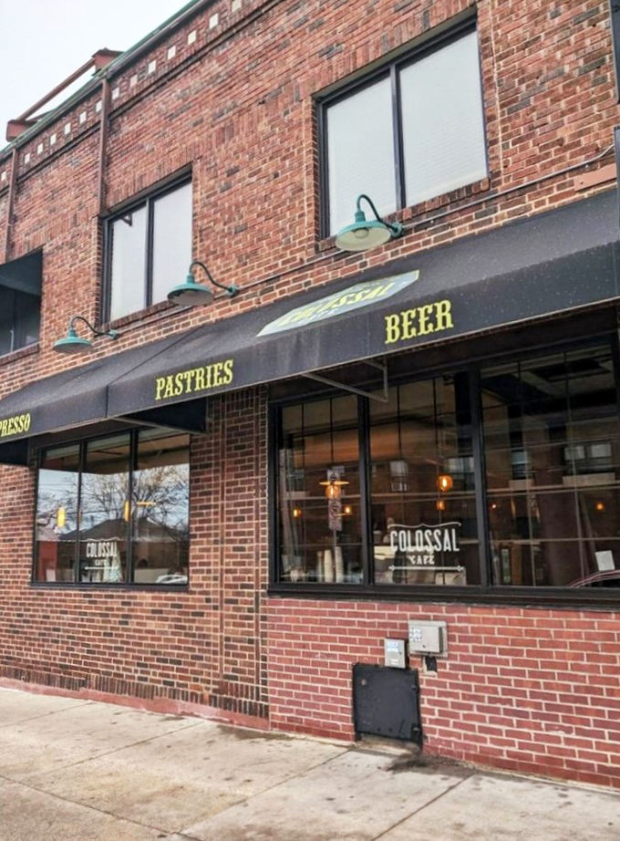Colossal Cafe: Where "pastries" and "beer" share equal billing. This brick beauty's awning promises a carb lover's paradise!