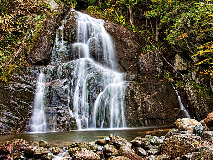 Nature's own waterfall masterpiece! Moss Glen Falls cascades down like a liquid staircase, inviting you to climb &ndash; with your eyes, of course.