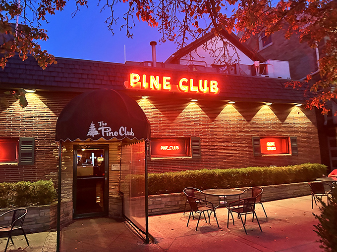 "Neon dreams and beefy schemes! The Pine Club's sign beckons like a lighthouse for the protein-starved."
